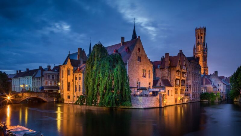 From Amsterdam: Bruges Day Trip in Spanish with Boat Option - Starting Point and Transportation