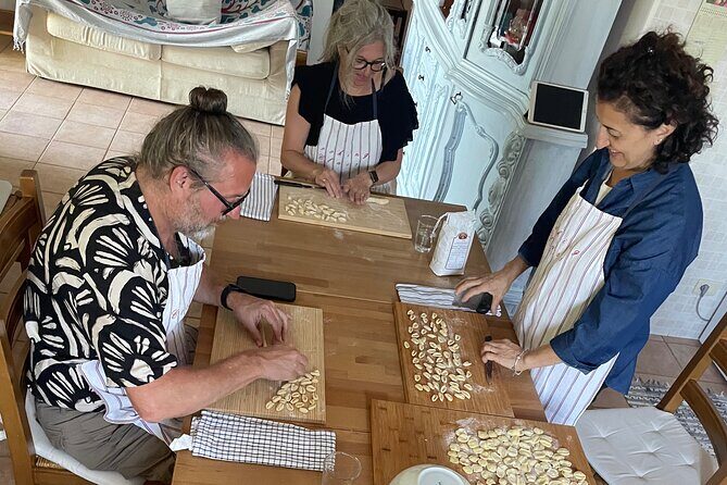 Hands in dough between orecchiette and focaccia in nature - FAQ