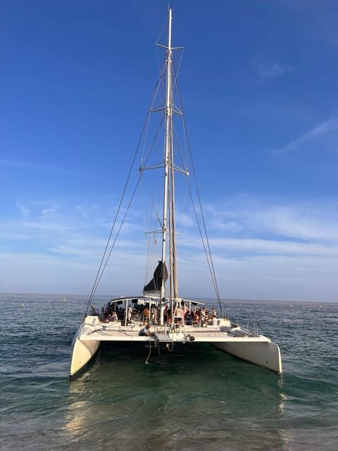 Lloret de Mar: Sunset Catamaran Cruise with DJ and Drinks - The Cruise Itinerary: From Shore to Secluded Bay