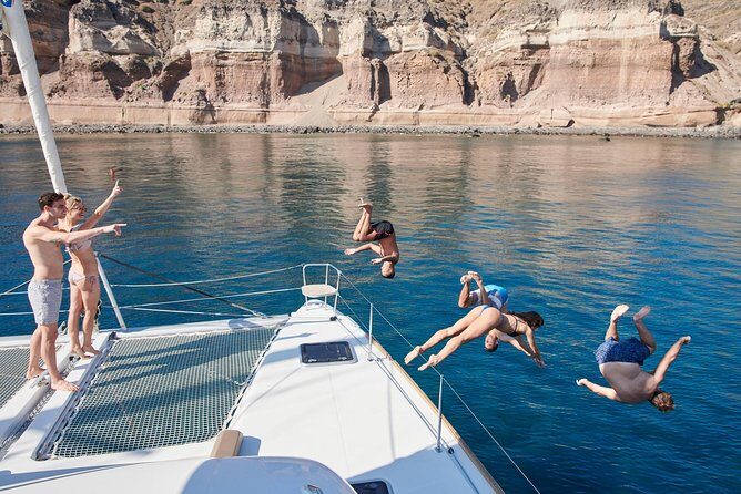Santorini Gold Catamaran Cruise with BBQ, Drinks and Hotel Pickup - The Sum Up