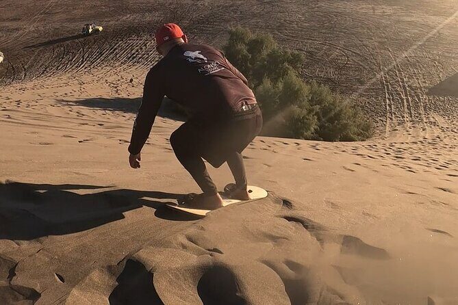 Slide into the sunset by Sandboarding in Las Dunas Del Mogote - Introduction to the Las Dunas Del Mogote Sandboarding Tour